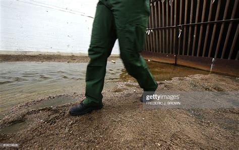 Us Border Patrol Agent Asael Blanco Walks Past Running Water In An
