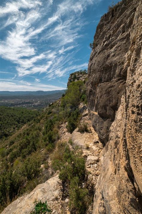 Landscape Of Rocky Cliffside Path Overlooking Lush Green Valley With