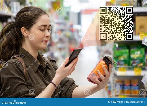 Young Beautiful Woman Scans A Qr Code Product In The Supermarket The