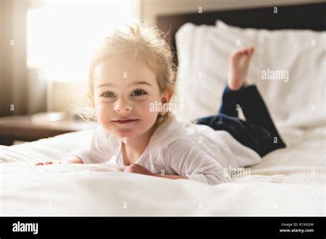 A Young Daughter Two Years Old Relaxing In Bed Positive Feelings Stock