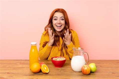 Premium Photo Teenager Redhead Girl Having Breakfast In A Table With Surprise Facial Expression