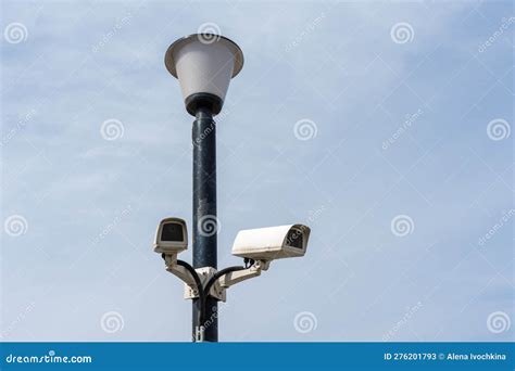 Surveillance Cameras Mounted On A Lamp Post Against A Blue Sky Security Cctv Camera Security