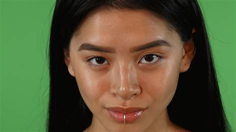 Beautiful Young Asian Woman With Lip Piercing Smiling To The Camera