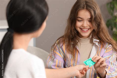 Mother Giving Condom To Her Teenage Daughter At Home Sex Education