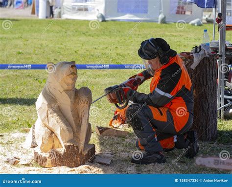 Man Cuts A Figure From A Tree With Chainsaw Editorial Photo Image Of