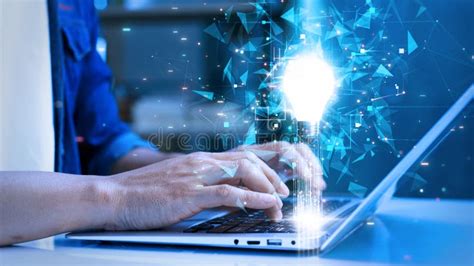 hands typing on a laptop with a glowing lightbulb and futuristic