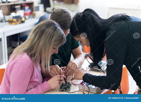 scientists engineers designing small human robot setting artificial