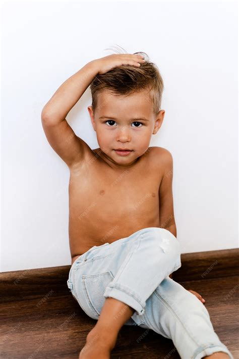 Premium Photo Cute Little Boy Wearing Blue Jeans Posing Against White