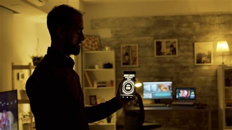 Premium Photo Man Using A Smart Lights Application To Turn On The Light Bulbs In The House