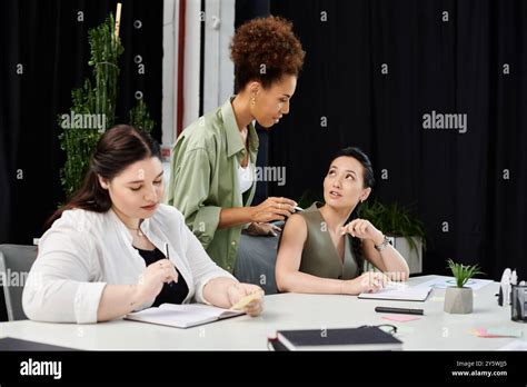 Three Elegant Businesswomen Engage In Lively Discussion While Working