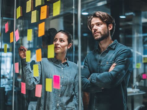 Team Brainstorming Session With Sticky Notes In Modern Office Presentationgo