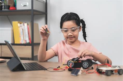 Premium Photo Asian Littlle Girl Constructing And Coding Robot At Stem Classfixing And Repair