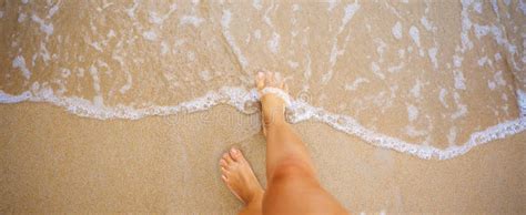 A Beautiful Girl In A Bikini On A Wild Beach Bathing In The Clear Waves Of The Warm Sea A