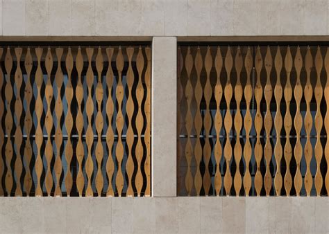 Wavy Wooden Shutters Cover Gridded Apartment Block In Iran