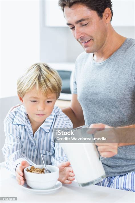 Father Pouring Milk Onto Sons Cereal Stock Photo - Download Image Now - 4-5 Years, 45-49 Years ...