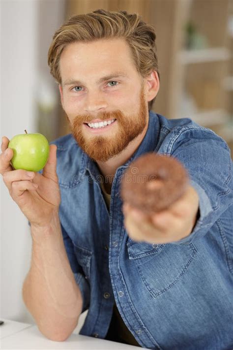 Young Smiling Man Holding Apple And Donut Stock Image Image Of Vegetable Smile 324569495