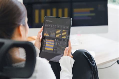 Businesswoman Interacts With A Digital Sales Dashboard Displaying