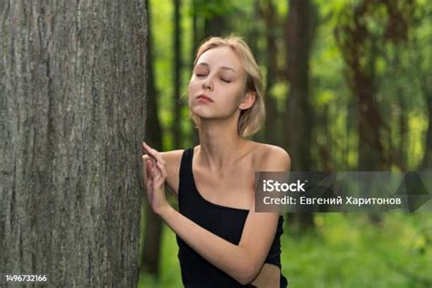 Стокове фото Красива Дівчина Слухає І Торкається Дерева В Лісі В Лісі — Завантажте зображення