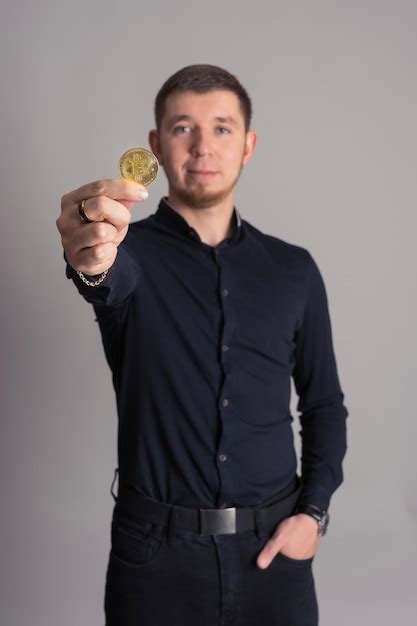 Premium Photo Confident Bearded Man Holding Bitcoin At Arm S Length Selectively Focusing