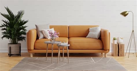 흰색 벽 배경에 가죽 소파가 있는 따뜻한 색조의 거실 내부 벽 모형3d 렌더링 사진 Unsplash의 실내 이미지