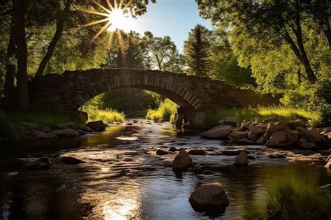 Premium Photo Sunlit Stone Arch Bridge Over A River