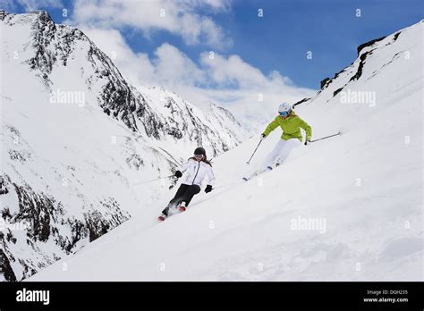 Two Women Skiing Stock Photo Alamy