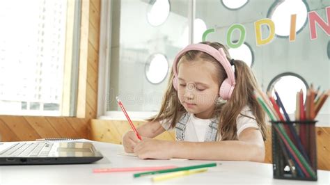 Cute Girl Doing Classwork Or Online Learning While Listen To Teacher Erudition Stock Image
