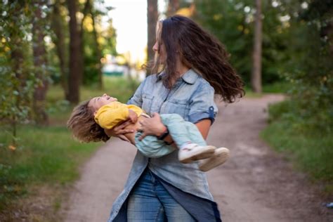 Premium Photo Mother Playing With Daughter While Standing Outdoors