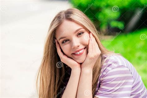 Photo Of Adorable Sweet Lady Wear Striped T Shirt Smiling Arms Cheeks