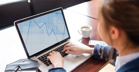 Premium Photo Woman Using Laptop Displaying Graph Chart On Screen