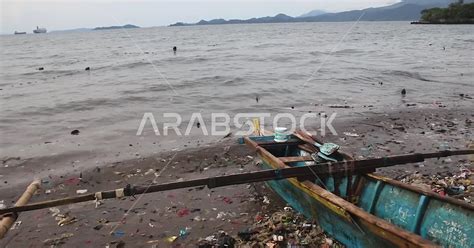 Fishing Boat Stuck On A Beach Full Of Rubbish Environmental Pollution
