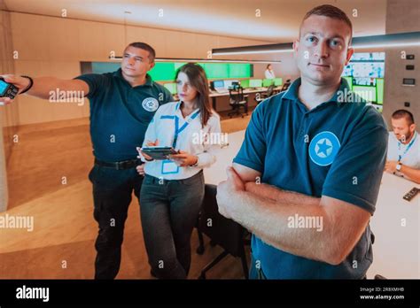 Group Of Security Operators Working In A Data System Control Room Technical Operators Working At
