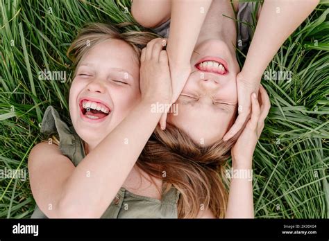 Brother And Sister Having Fun Together Lying On Grass Stock Photo Alamy
