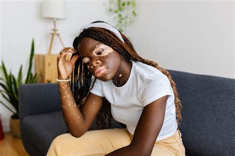 Pensive Young African Woman Feeling Worried Sitting On Sofa At Home