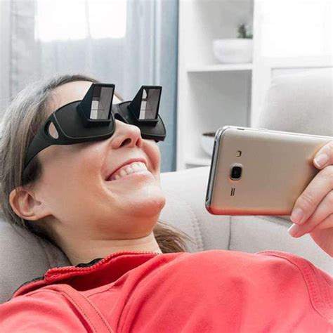 A Woman Laying On A Couch Wearing Blindfolds And Looking At Her Cell Phone