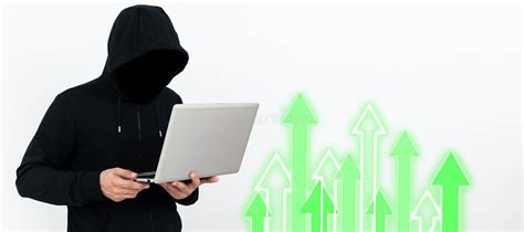 male programmer in black hoodie stands and holds laptop hacker with