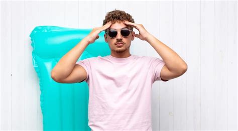 Premium Photo Young Man With An Air Mattress