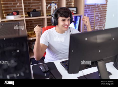 Non Binary Man Streamer Playing Video Game With Winner Expression At