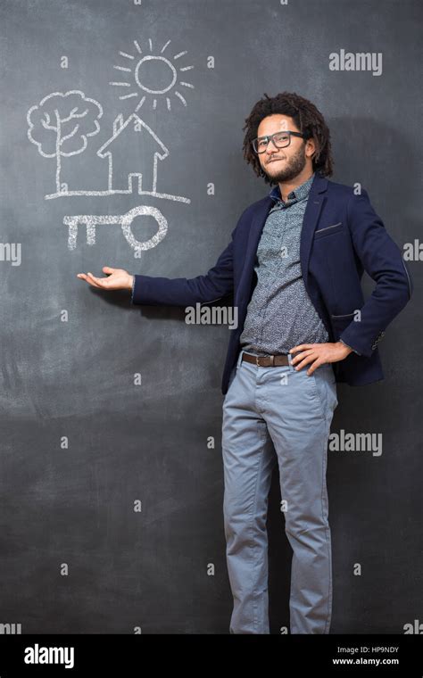 Real Estate Concept Portrait Of Man In Front Of Chalkboard With House Key Stock Photo Alamy