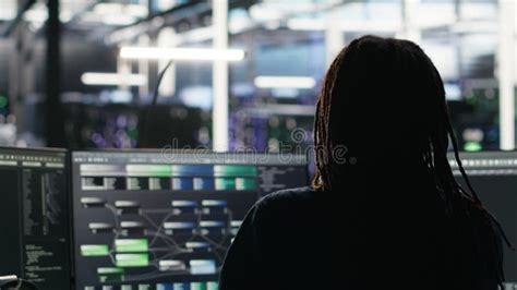 Data Center Engineer Using Algorithms To Analyze Datasets Putting On Headphones Stock Video