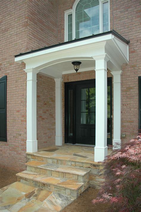Black Front Door On Brick House Porch Roof Design Overhangs For