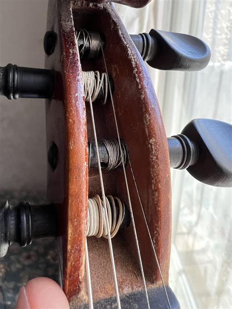 why do my strings touch eachother in the pegbox also are they too