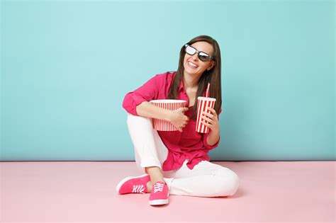 전체 길이 세로 재미 여자 장미 셔츠에서 흰색 바지 밝은 핑크 블루 파스텔 벽 배경 스튜디오에 고립 된 보고 영화 필름을 바닥에