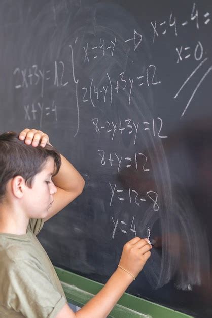 Premium Photo Side View Of Male Student Solving Mathematics Problem