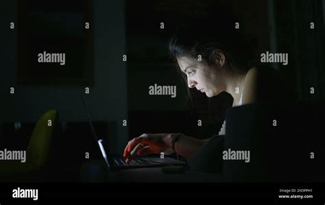 Woman Working At Night In Front Of Laptop Person Using Computer Studying In The Dark And