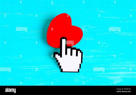 Plastic Pointer Cursor Touches A Red Heart Shape Isolated On Vibrant