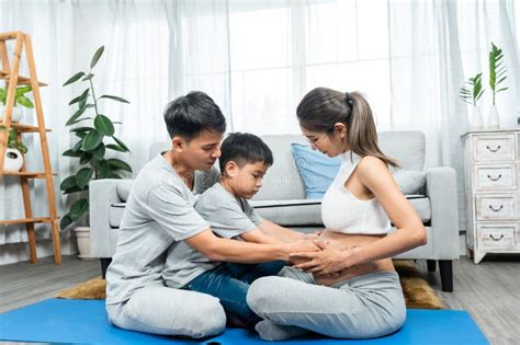 Beautiful Asian Mom Sitting On Carpet In Bedroom Father And Son Sit