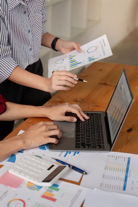 Business Team Collaboration On Data Analysis With Charts And Graph In Modern Office Setting