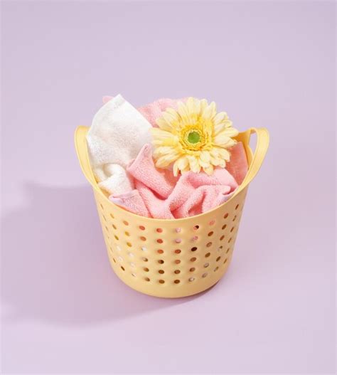 Premium Photo Yellow Laundry Basket With Washing Towels And A