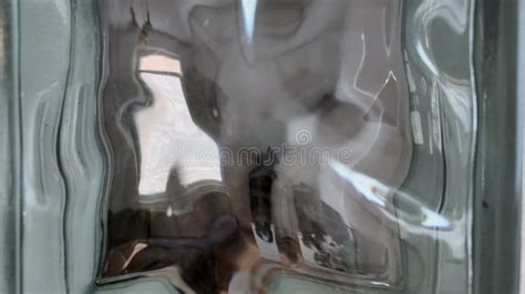 Distorted Reflection Of People And Furniture Through Textured Glass Window Stock Image Image